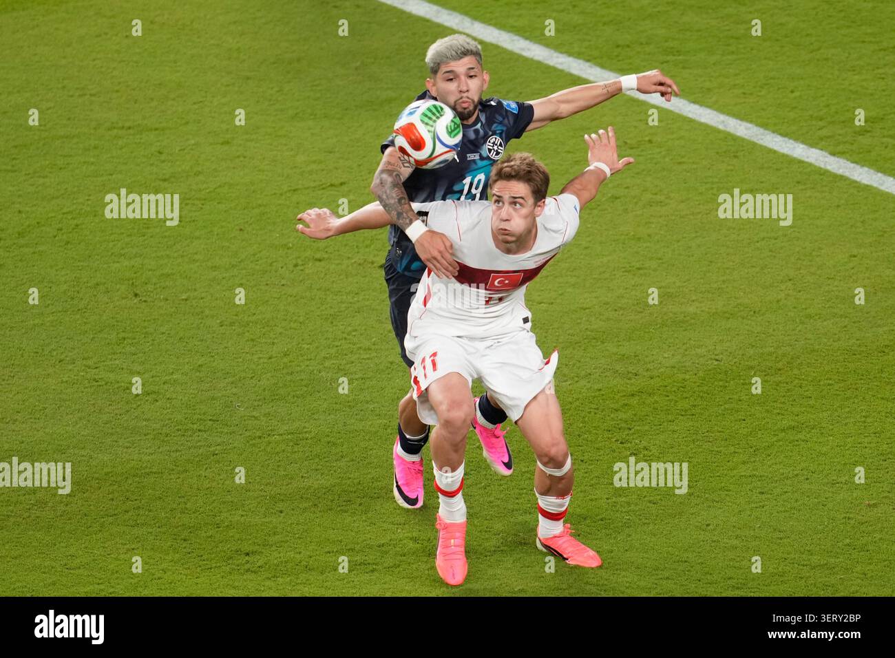 Turkey's Kenan Yildiz, front, and Paraguay's Julio Enciso battle for ...