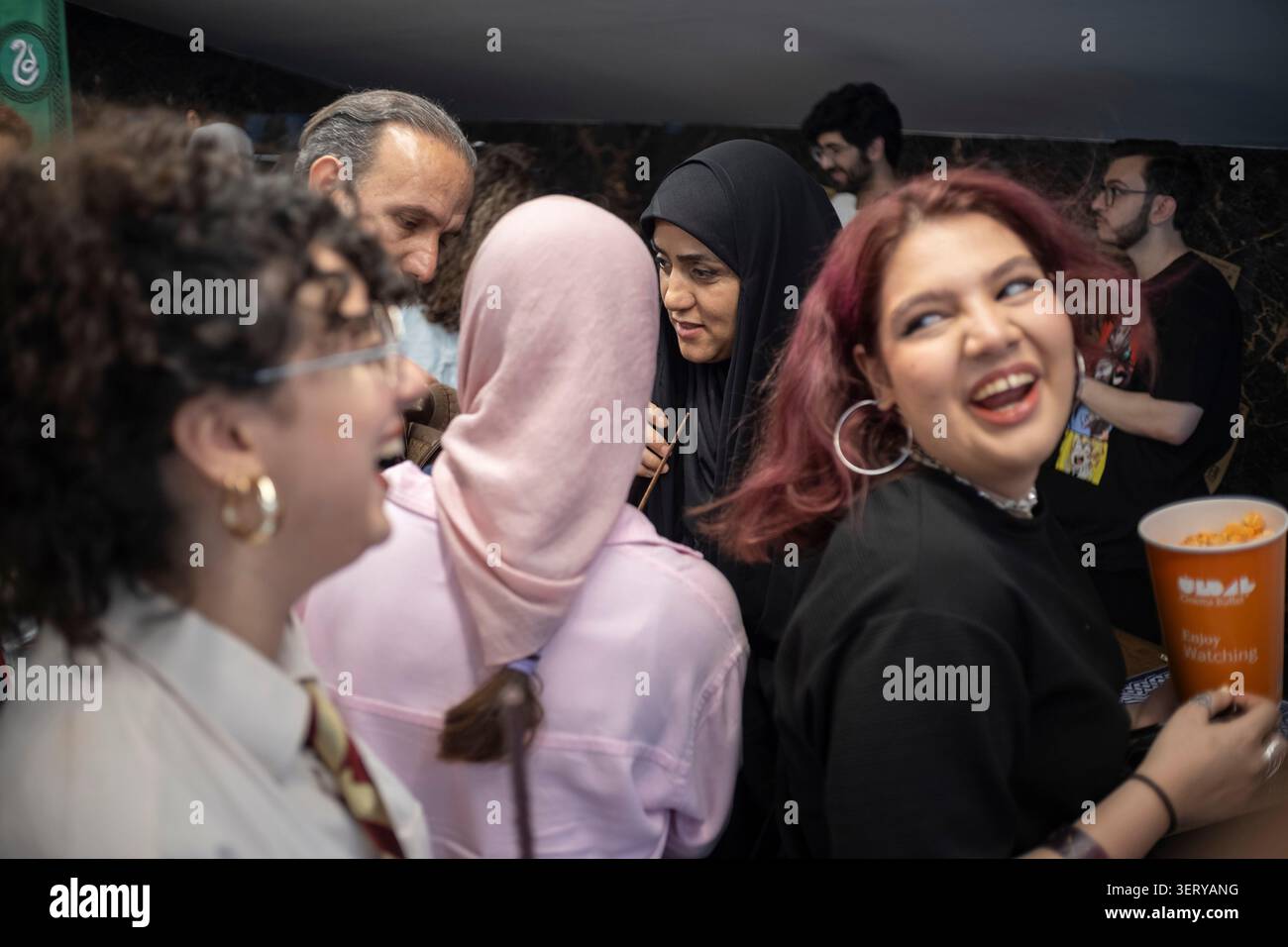A veiled Iranian woman participates with her family in a Harry Potter ...
