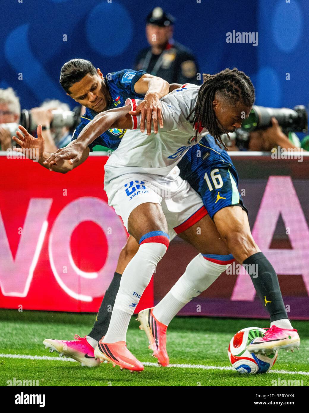 Douglas Santos (#16) and Jean-Kévin Duverne (#22) contest the ball ...