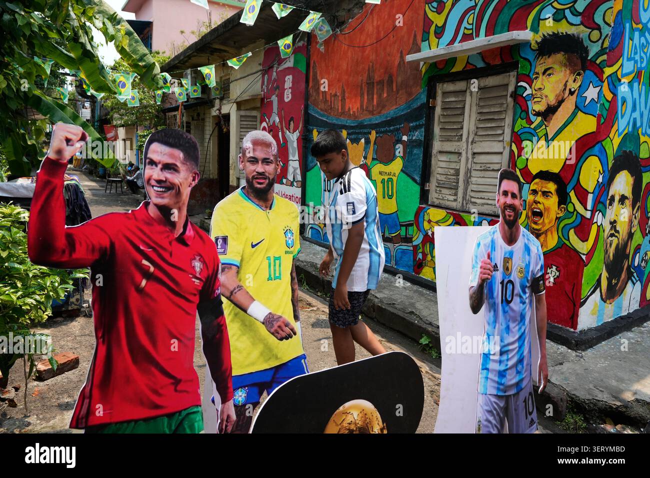 A fan walks past cutouts of Portugal's Cristiano Ronaldo, Brazil's ...