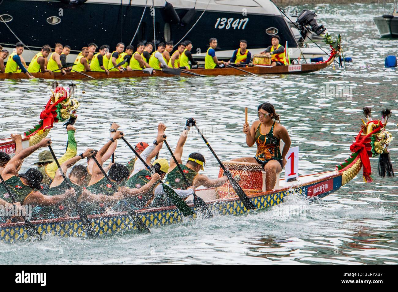 A dummer helps guide her team at the Dragon Boat Races in Aberdeen ...