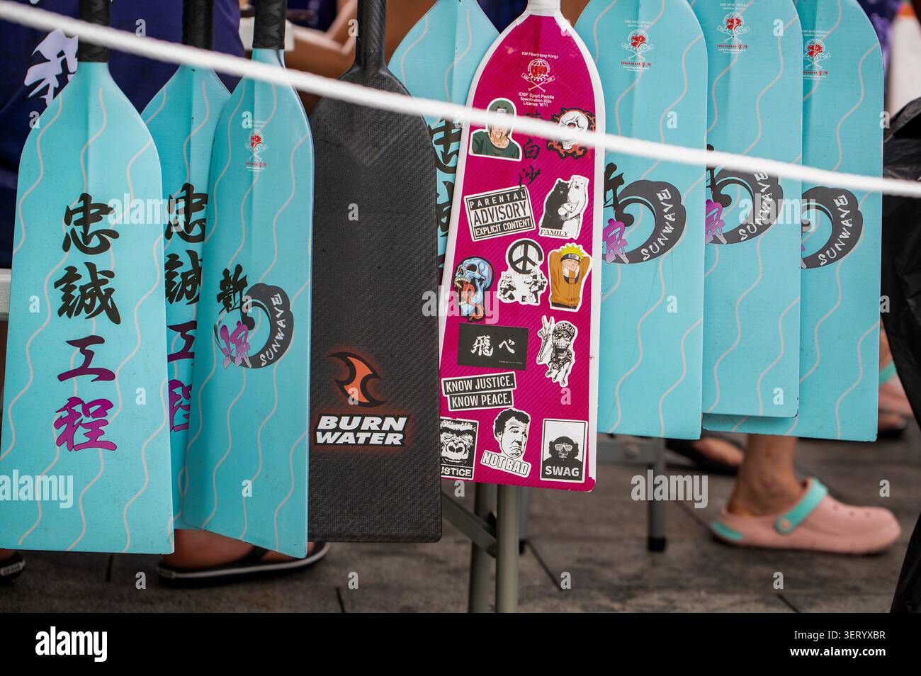 A variety of paddles hang along the shore in Aberdeen. Races are held ...