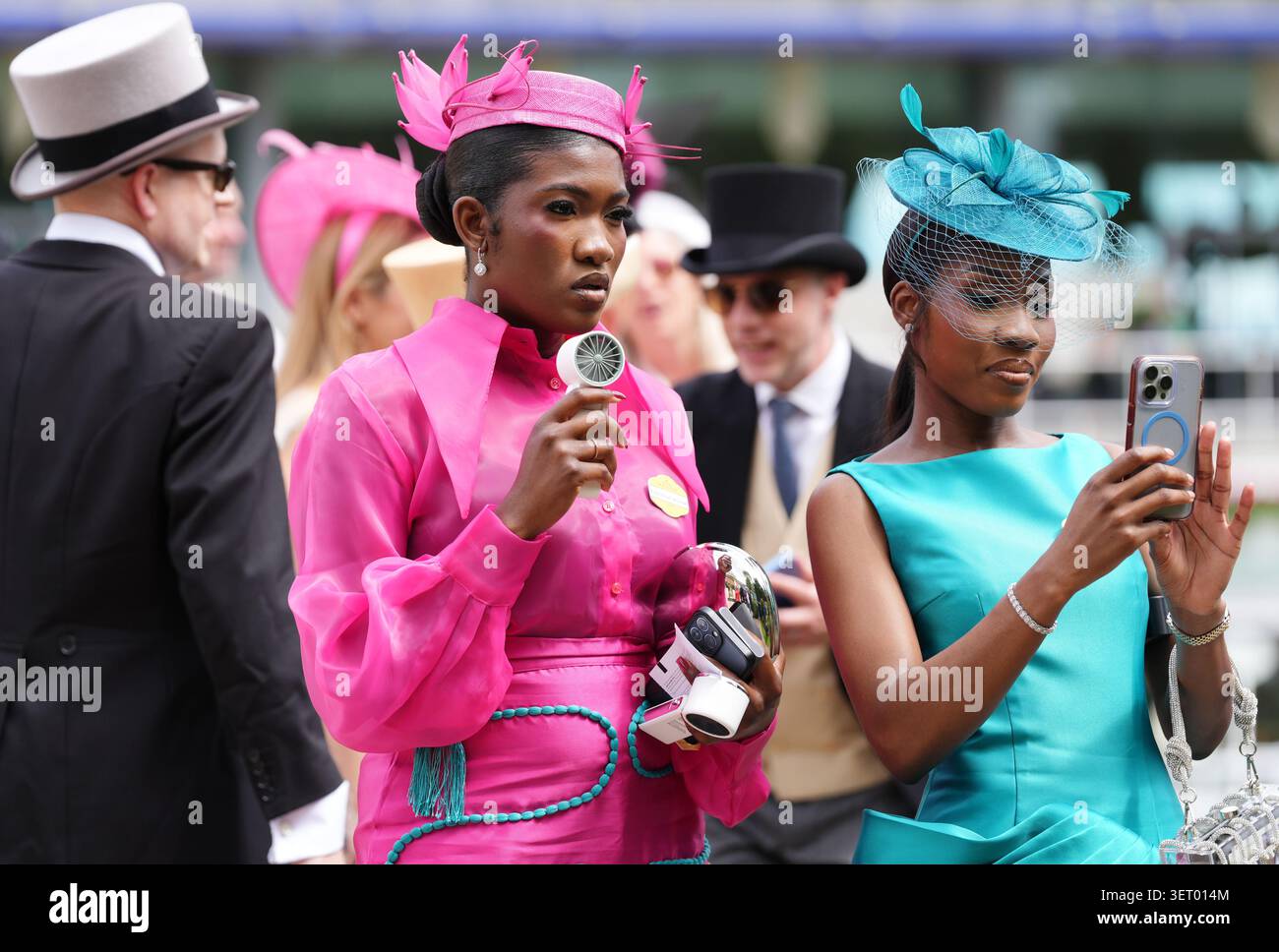 A racegoer uses a hand held fan on day five of Royal Ascot at Ascot ...