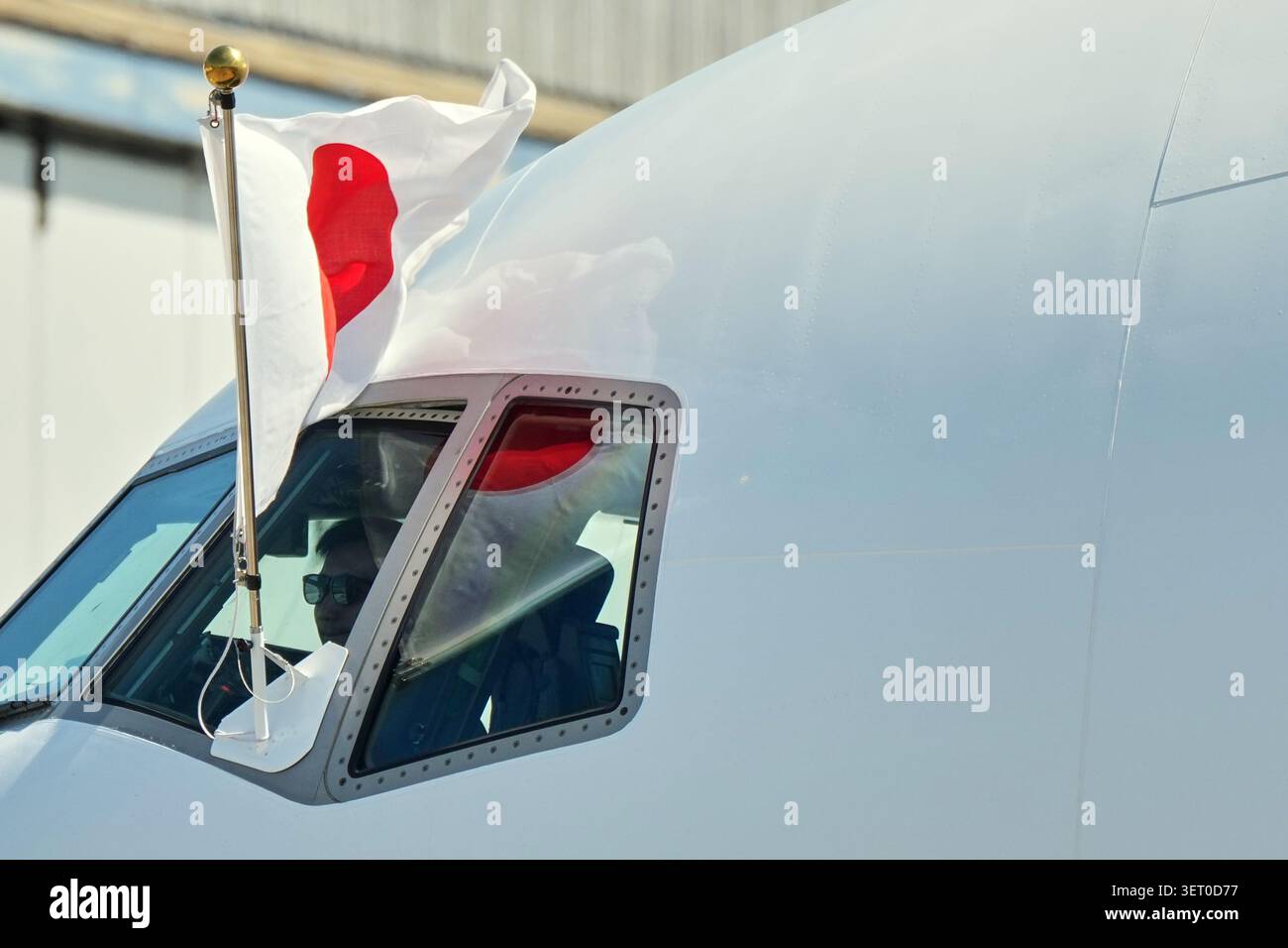 A pilot hangs the Japanese flag outside of the cockpit window as Japan ...