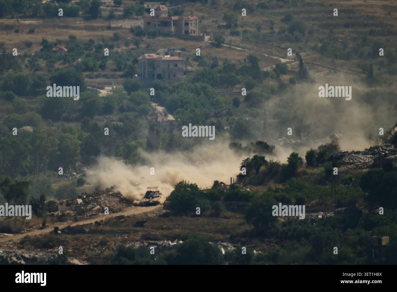 An Israeli tank moves past destroyed buildings in southern Lebanon as ...