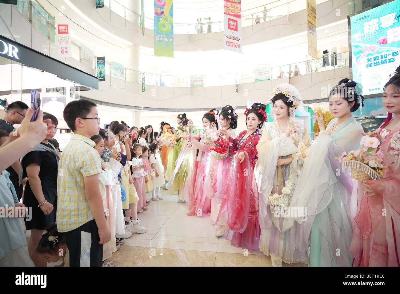 Performers dressed as 'Twelve Flower Goddesses' stage a traditional ...