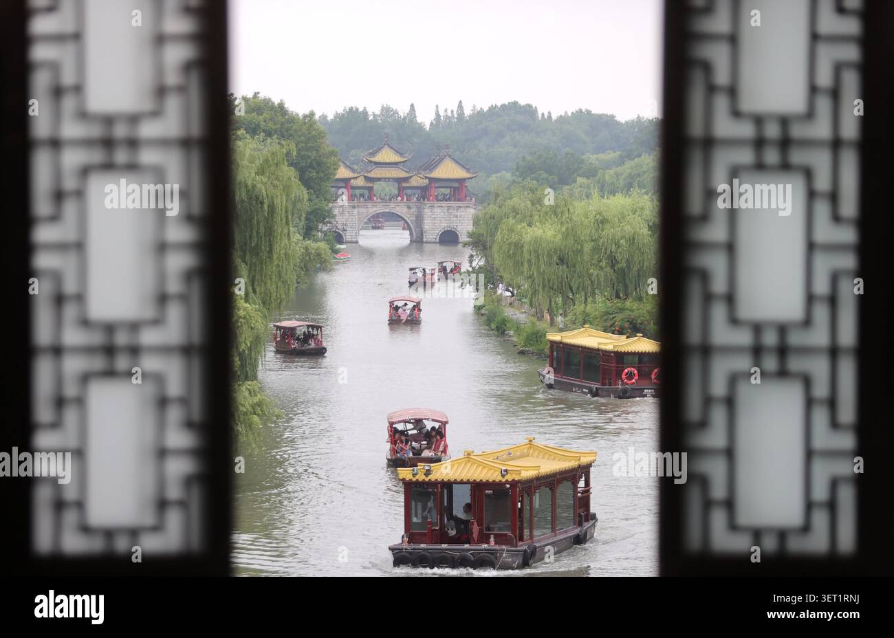 Tourists take a boat ride at the Slender West Lake scenic area in ...