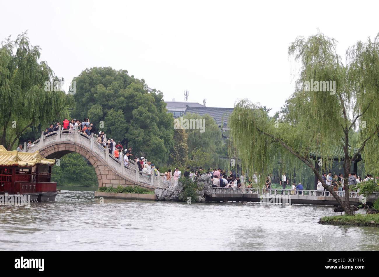Tourists take a boat ride at the Slender West Lake scenic area in ...