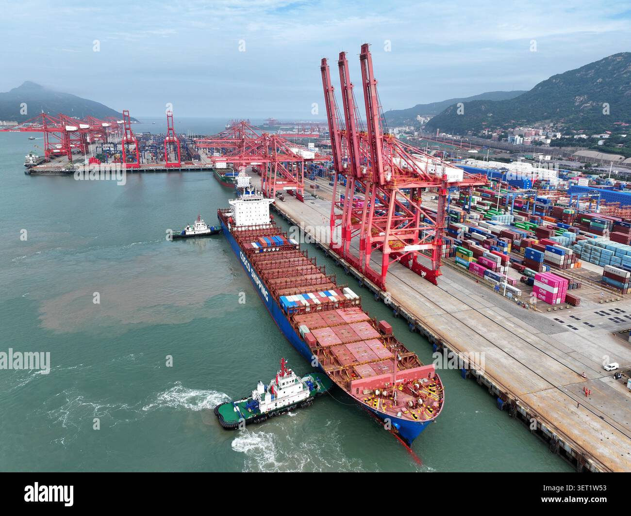 A cargo ship docks at a container terminal in Lianyungang Port, east ...