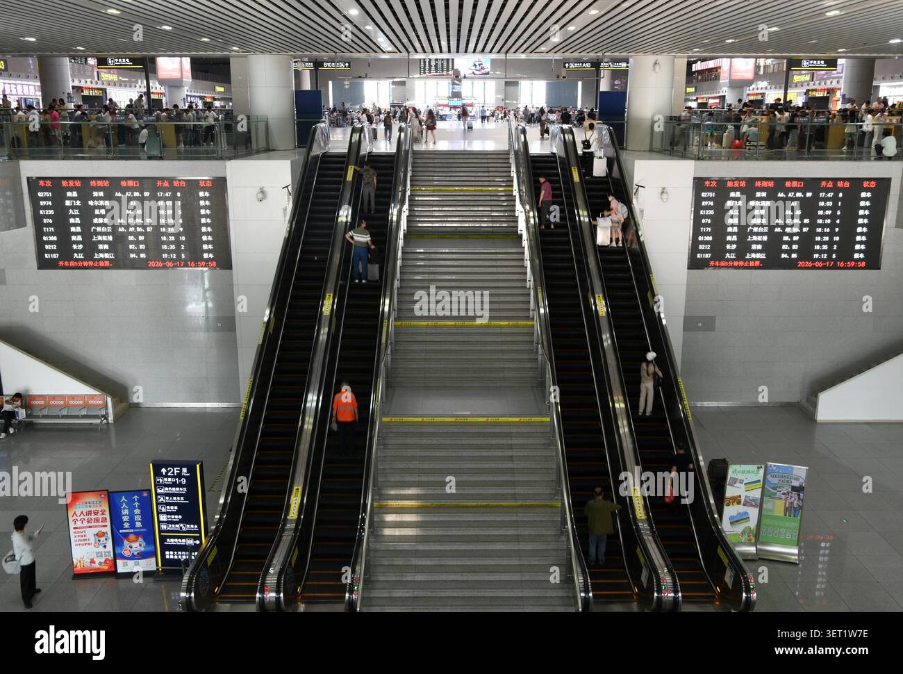 Passengers take an escalator to enter the waiting hall at Nanchang ...