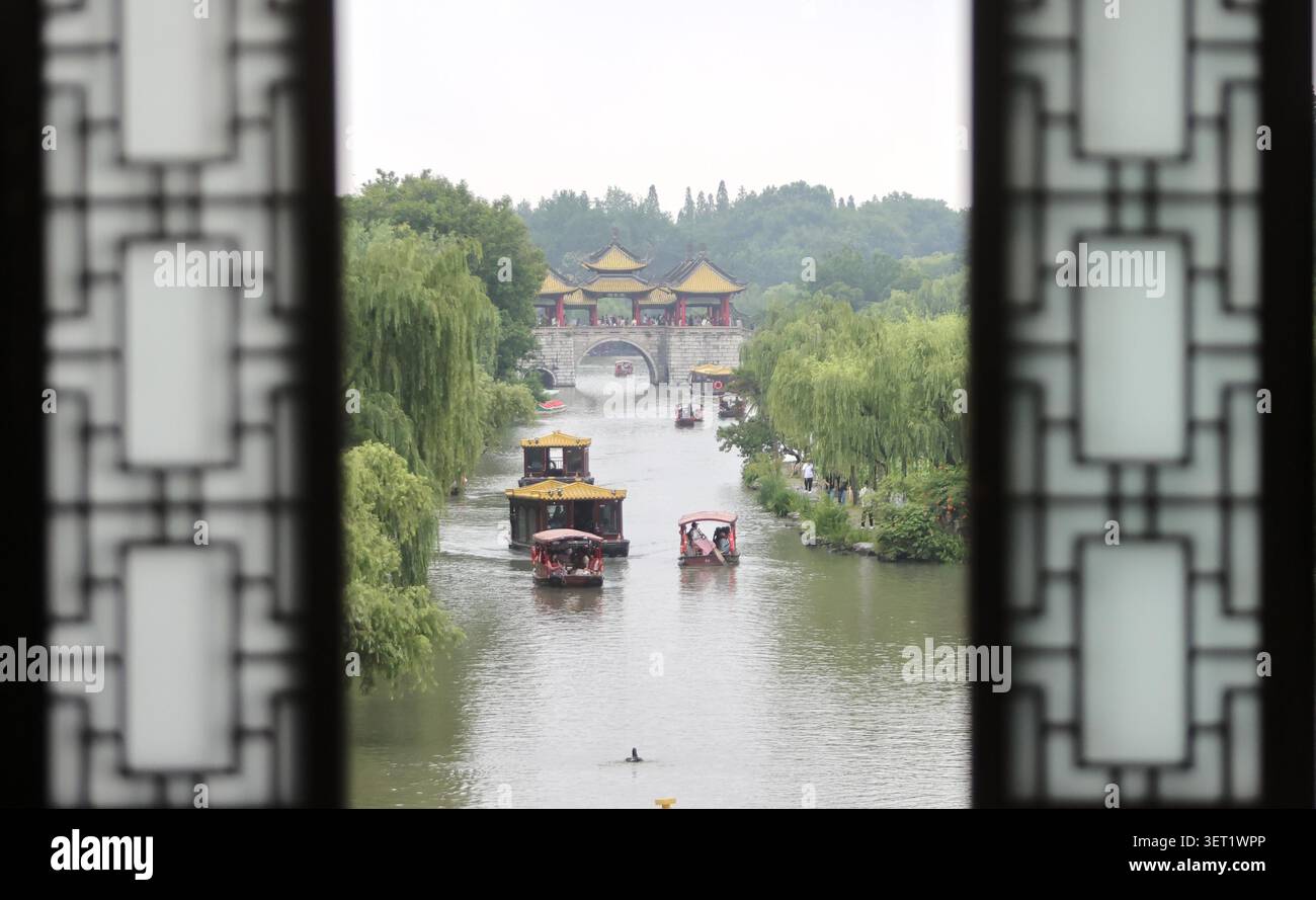 Tourists take a boat ride at the Slender West Lake scenic area in ...