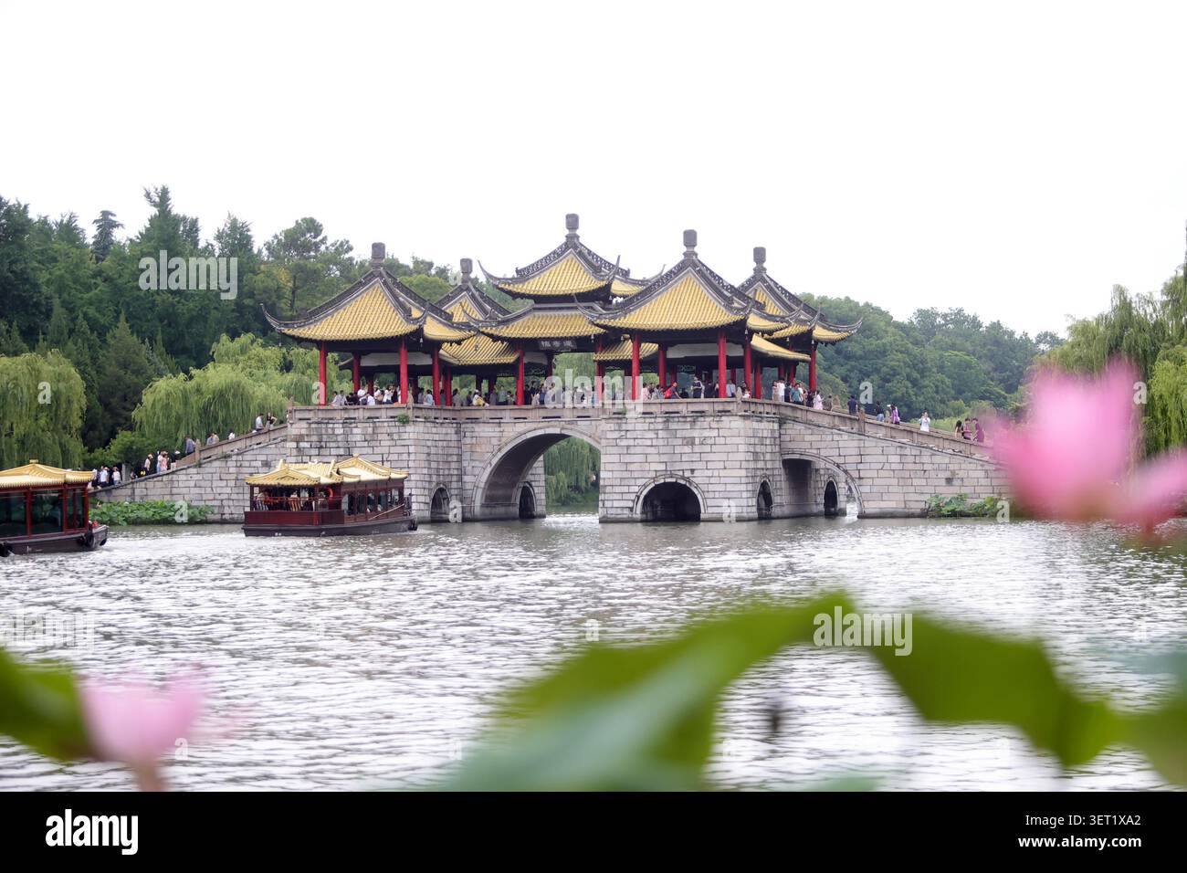 Tourists take a boat ride at the Slender West Lake scenic area in ...