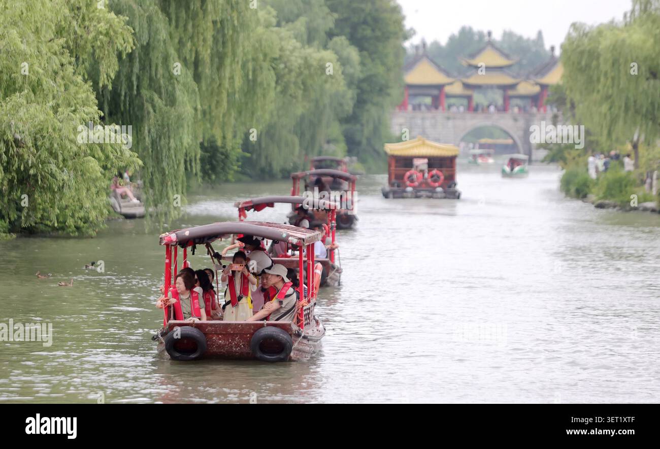 Tourists take a boat ride at the Slender West Lake scenic area in ...