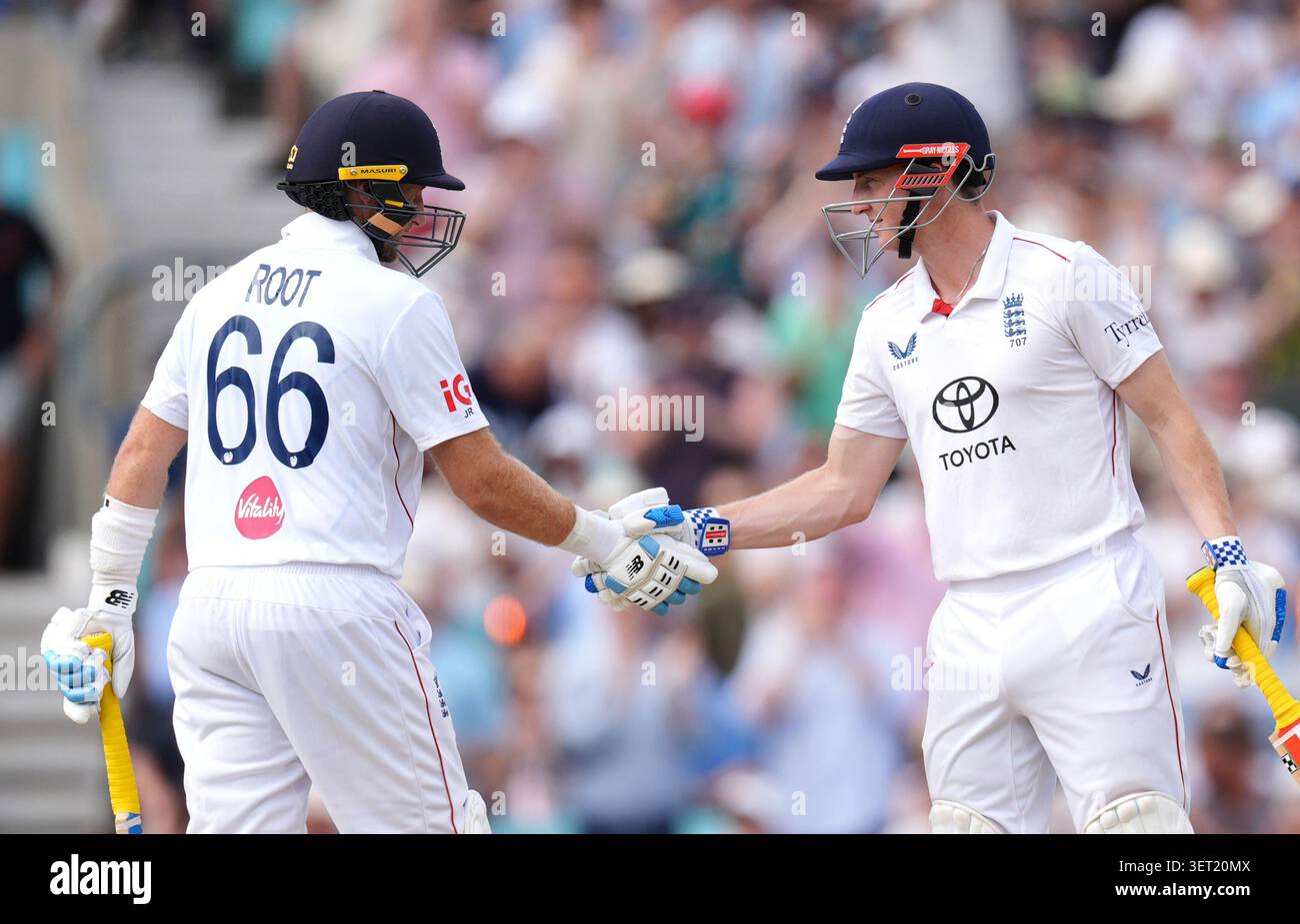 England's Harry Brook (right) congratulates batting partner Joe Root ...
