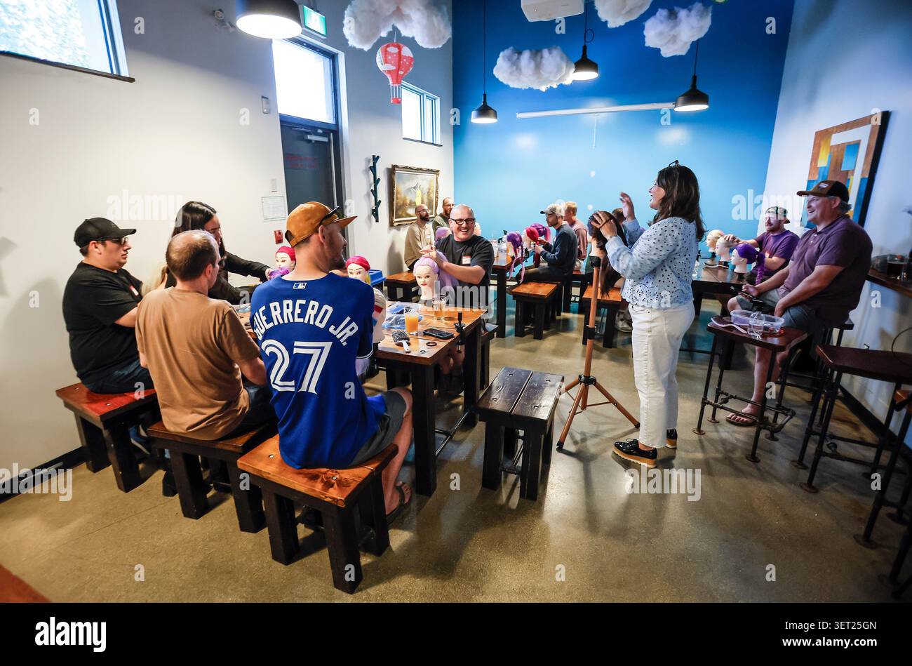 Ren Cherlet instructs fathers as they participate in "Beers and Braids ...