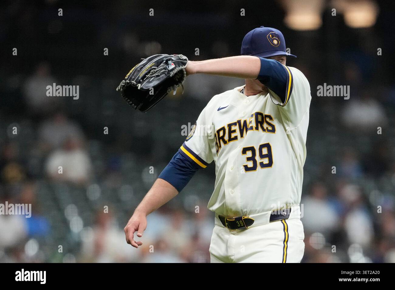 Milwaukee Brewers' Chad Patrick wipes his face as he walks to the ...