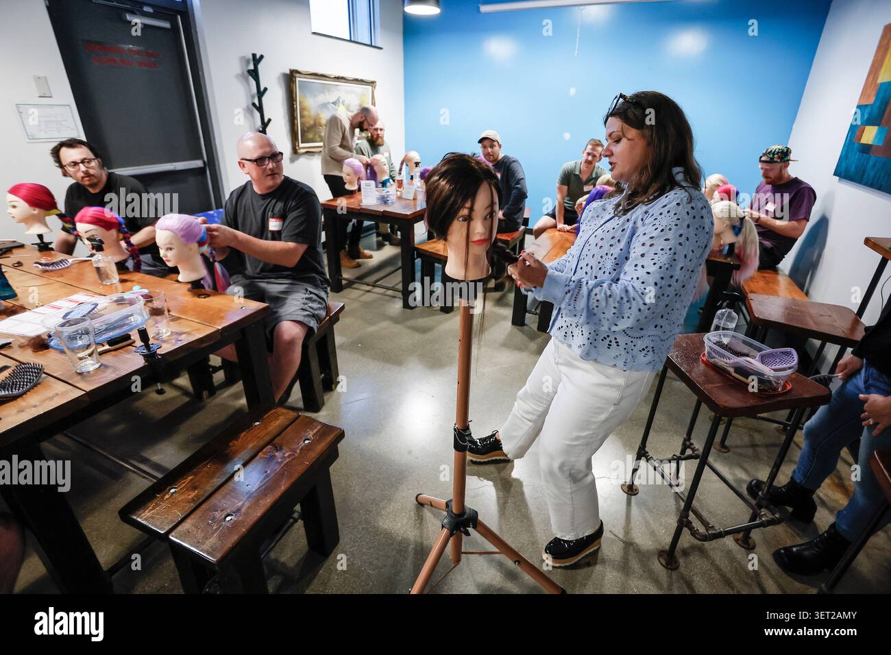 Ren Cherlet gives instruction to fathers as they participate in "Beers ...