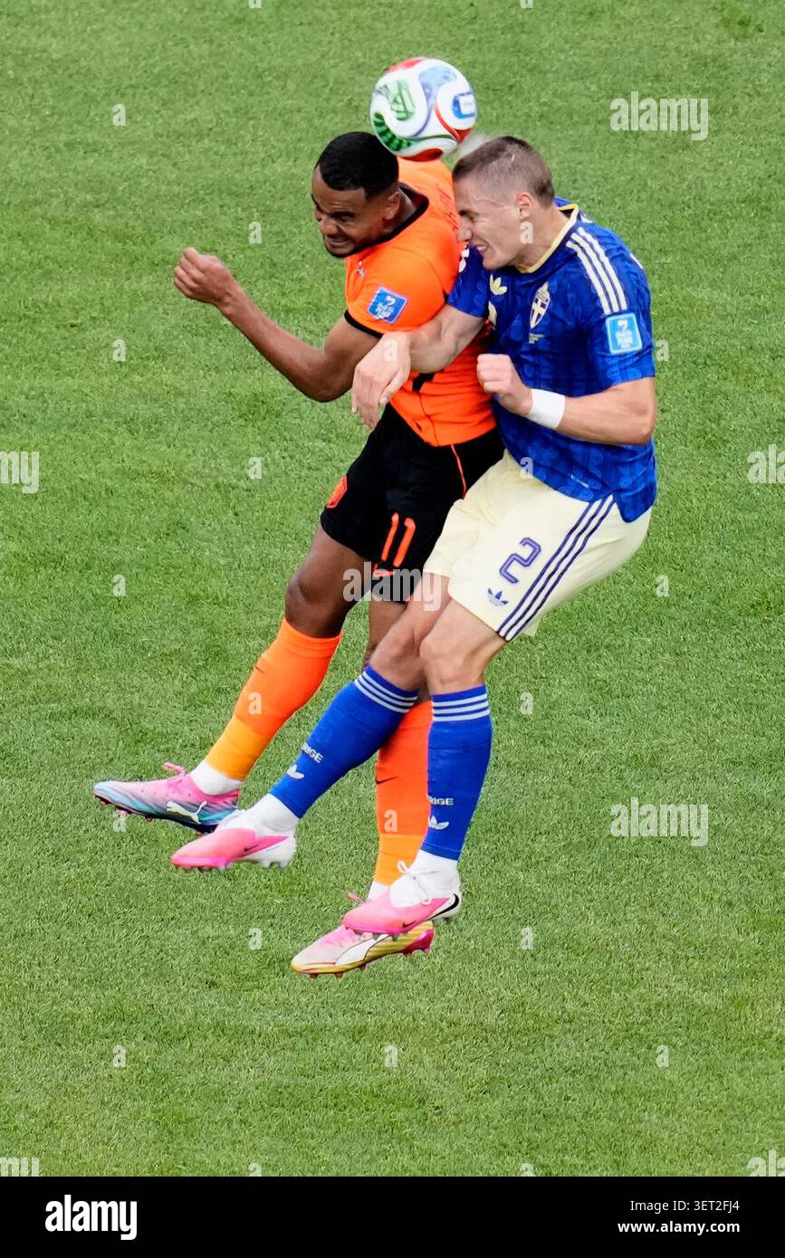 Netherlands' Cody Gakpo, left, and Sweden's Anthony Elanga battle for ...