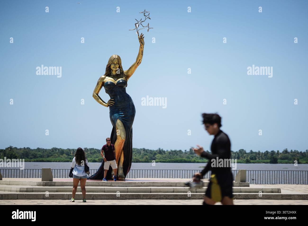 A statue of Colombian singer Shakira stands along the Magdalena River ...