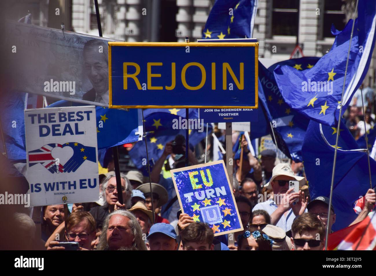 Protesters pass near Waterloo station with EU flags and pro-EU placards ...