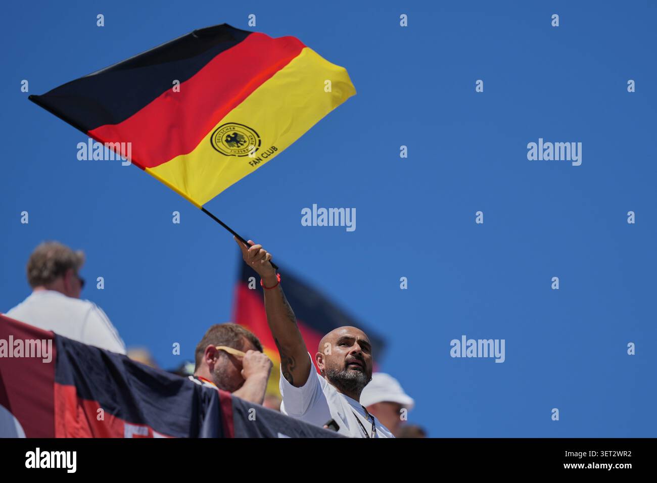 A German fan waves flag as he looks on from the stands ahead of the ...