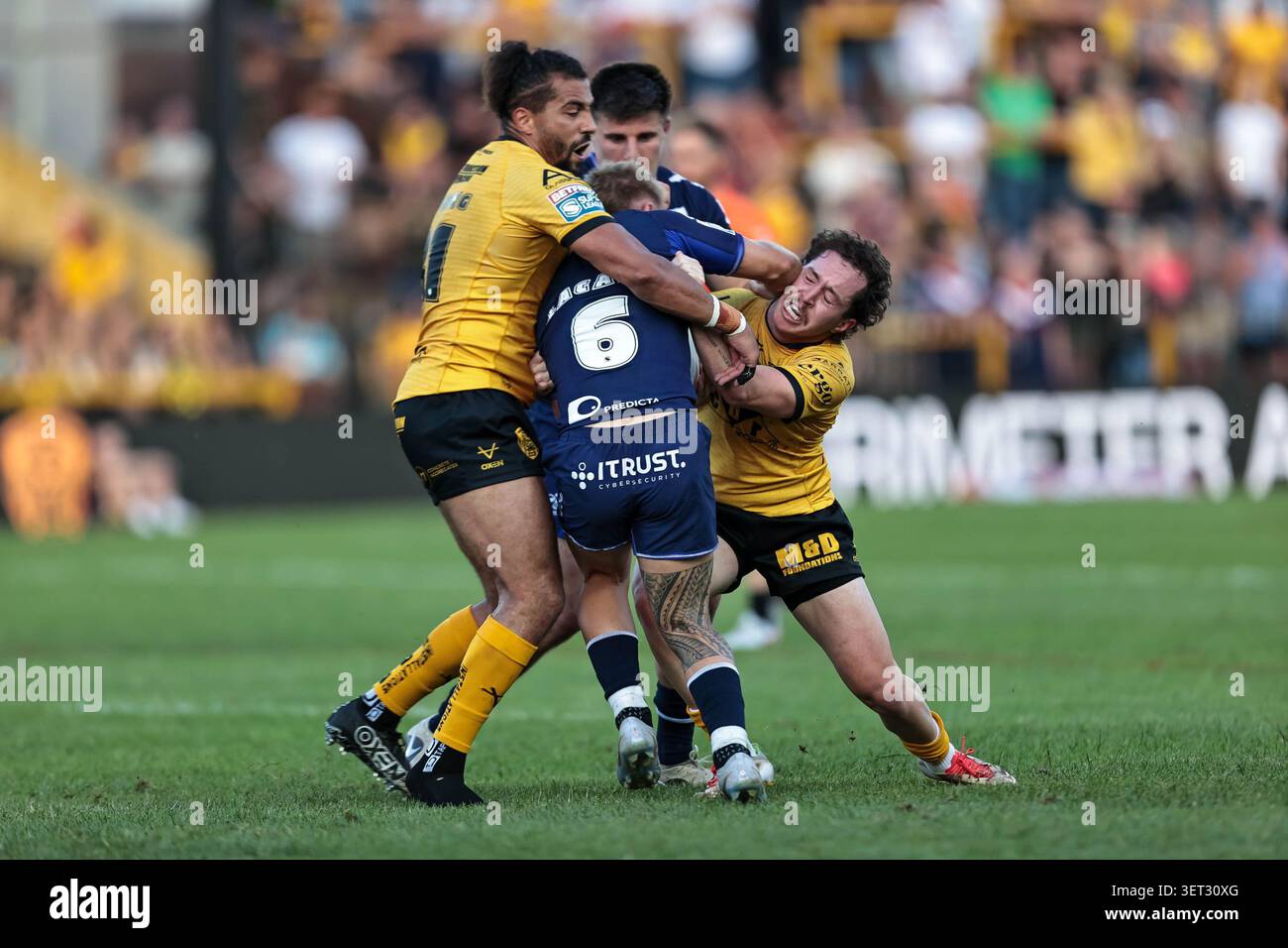 Ashton Golding and Tom Weaver tackle Thomas Lacans during the BetFred ...