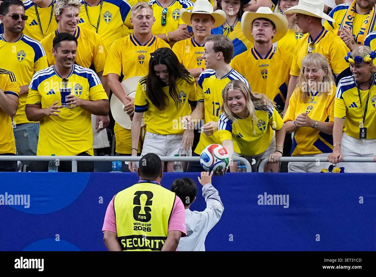 A Sweden fan returns a football that landed on the stands during the ...