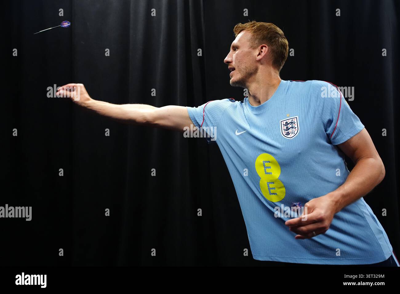 England's Dan Burn plays darts during a press conference at Swope ...