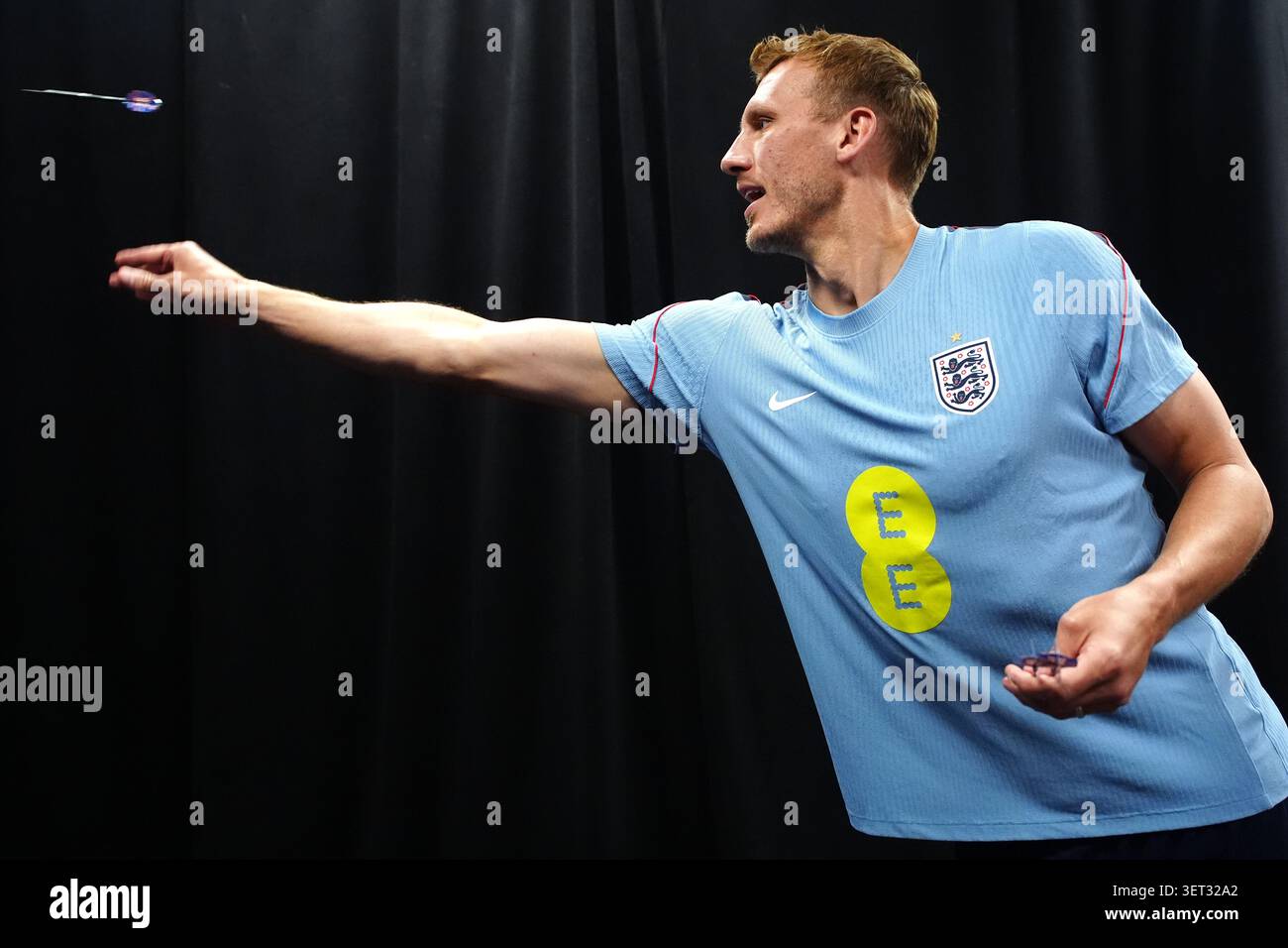 England's Dan Burn plays darts during a press conference at Swope ...