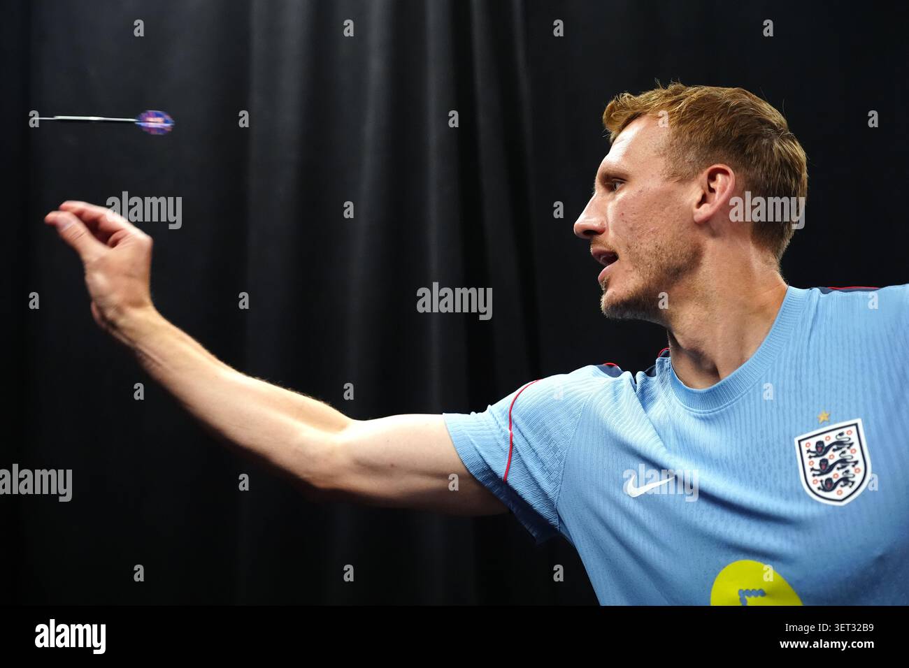 England's Dan Burn plays darts during a press conference at Swope ...