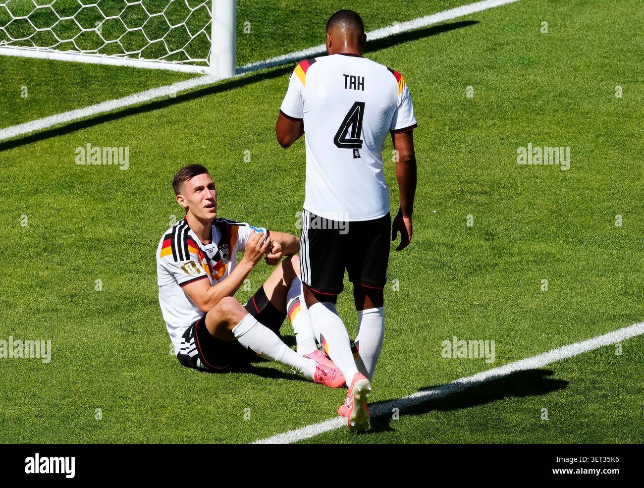Germany's Nico Schlotterbeck (15) sits as teammate Jonathan Tah (4 ...