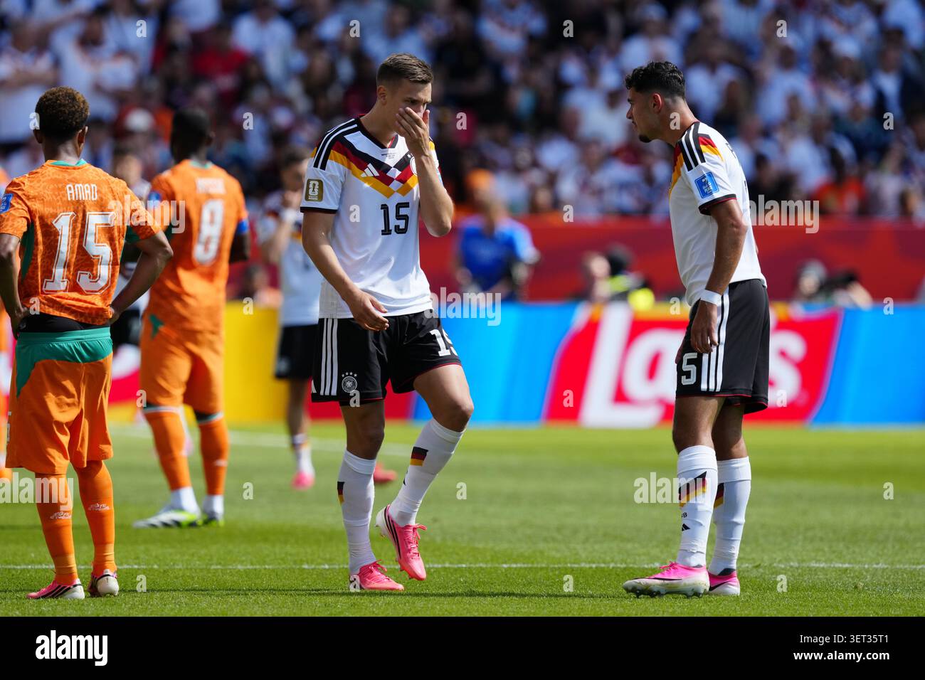 Germany's Nico Schlotterbeck (15) limps on the field after a tackle ...