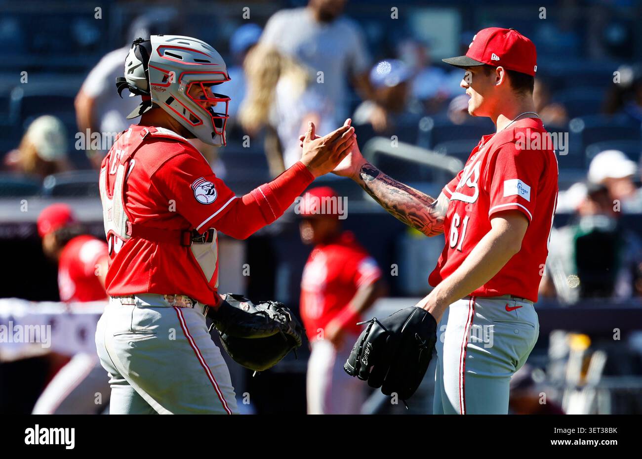 Cincinnati Reds catcher Jose Trevino and pitcher Chase Petty (61) shake ...