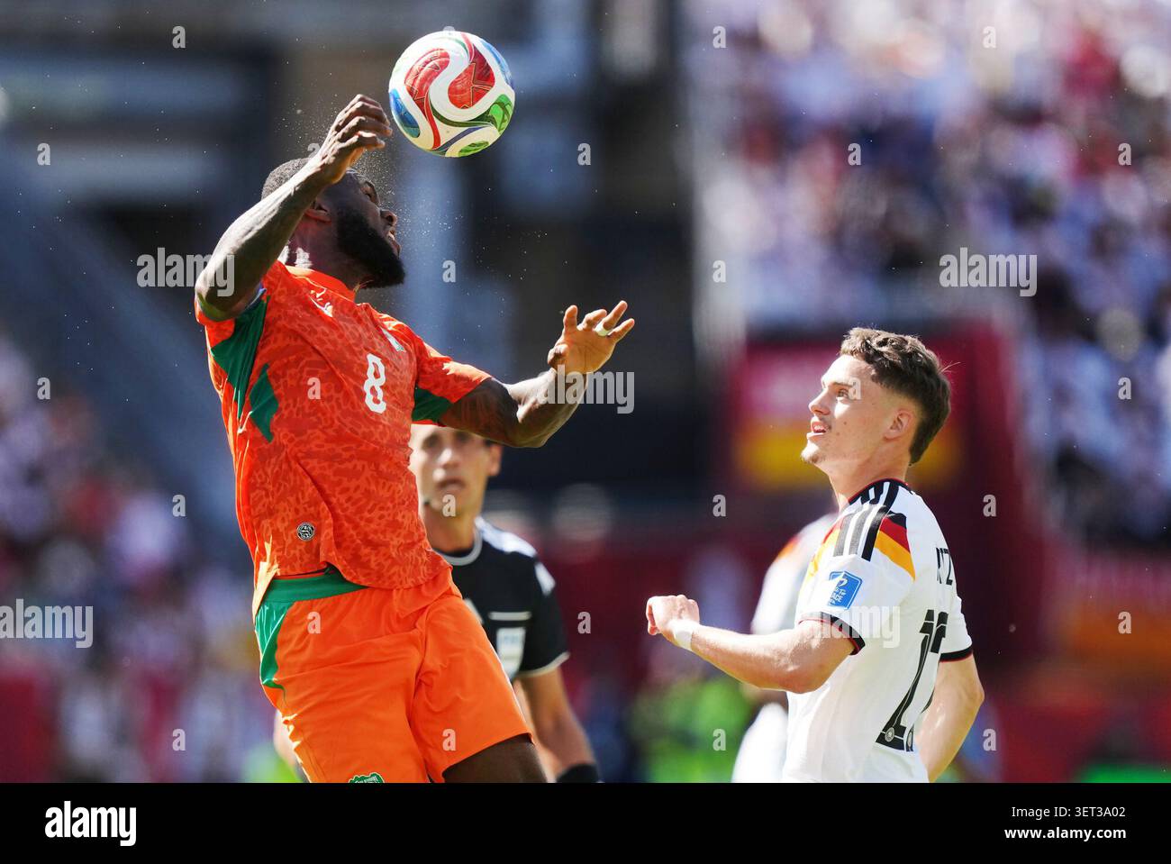 Ivory Coast's Franck Kessie (8) heads the ball over Germany's Florian ...