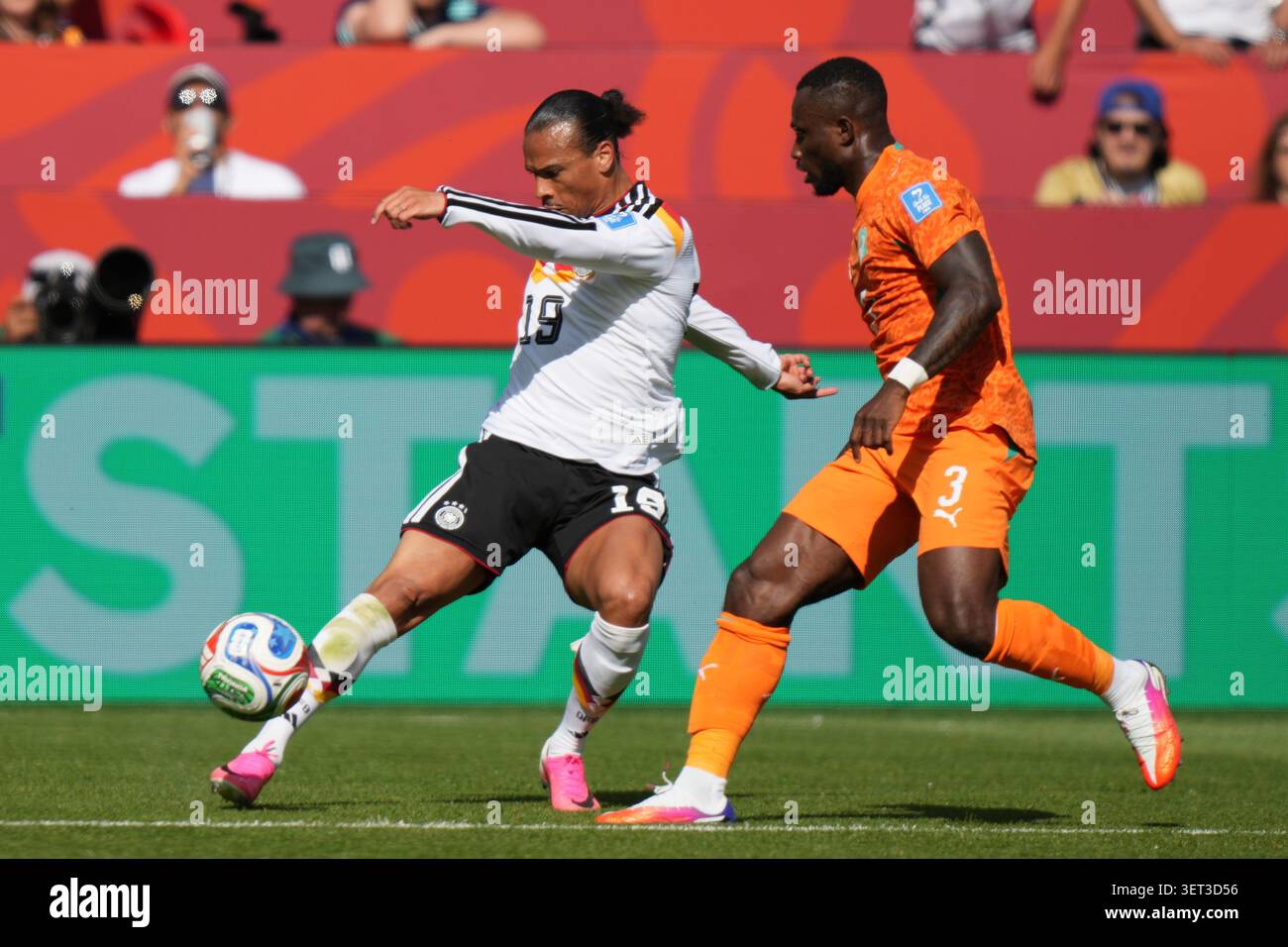 Germany's Leroy Sane, left, crosses the ball under pressure from Ivory ...