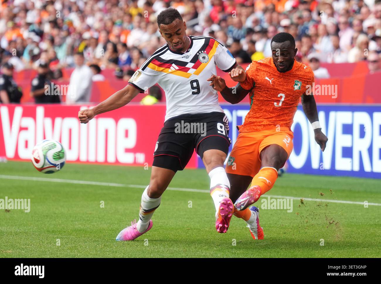 Ivory Coast's Ghislain Konan (3) plays the ball past Germany's Jamie ...