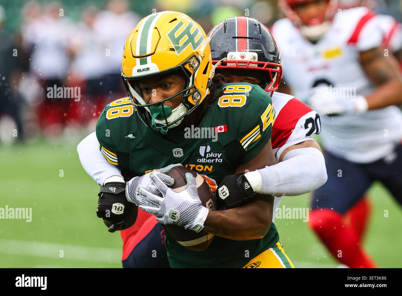 Edmonton Elks' TJ Luther (88) is tackled by Montreal Alouettes' Lorenzo ...