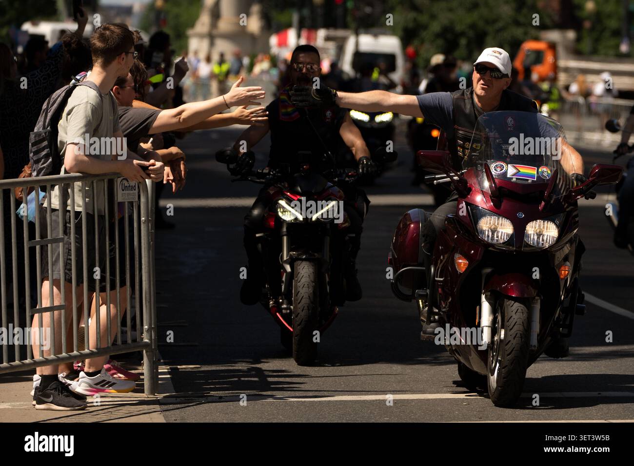 A motorcyclist high-fives spectators during the Washington Pride parade ...