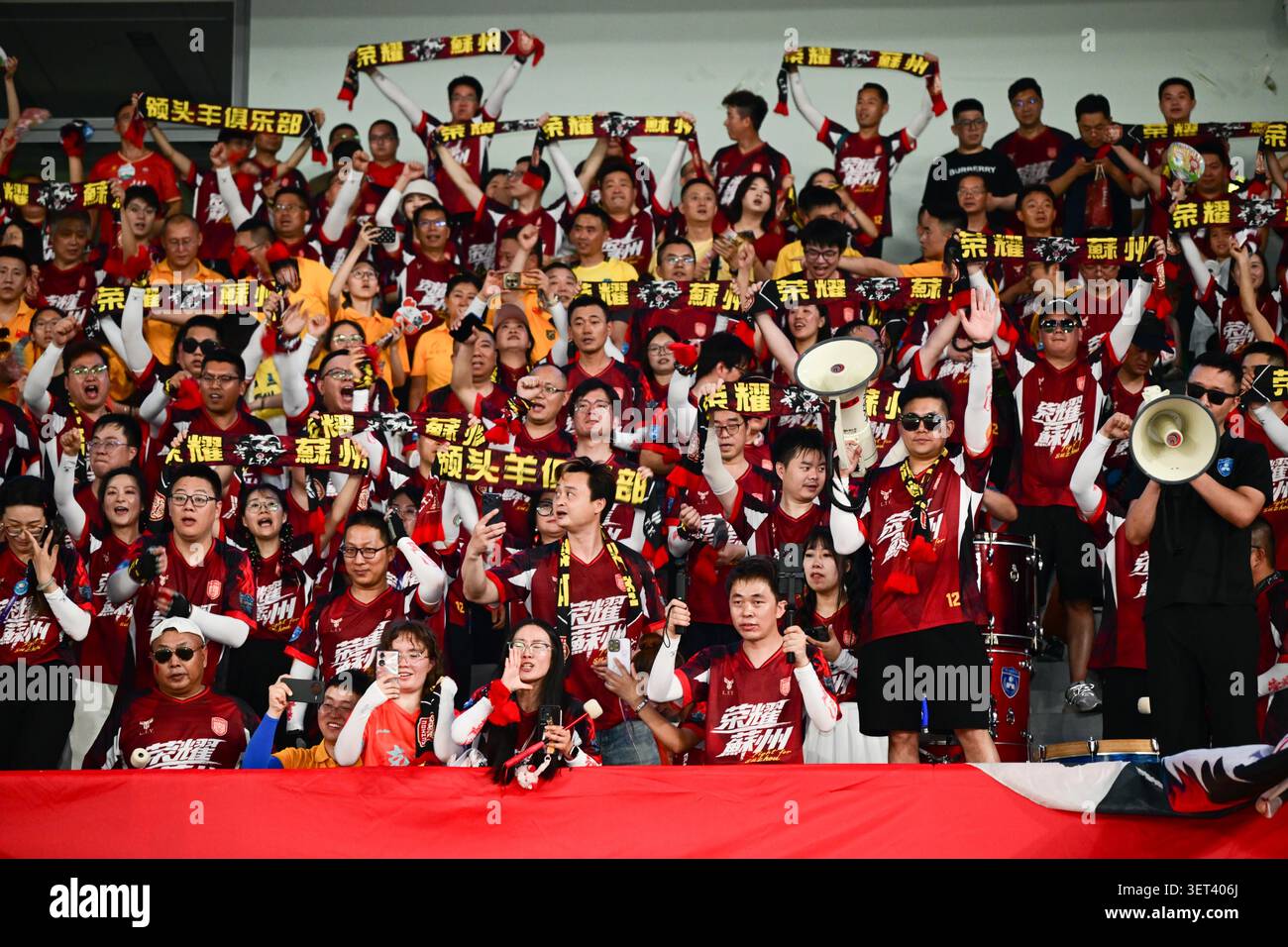 Fans cheer passionately for their teams during the Suzhou vs Nantong ...