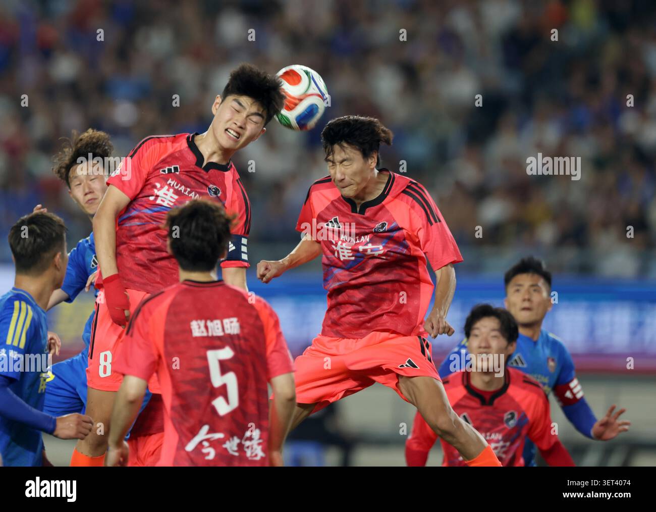 Players compete during the 10th week of Jiangsu Urban Football League ...