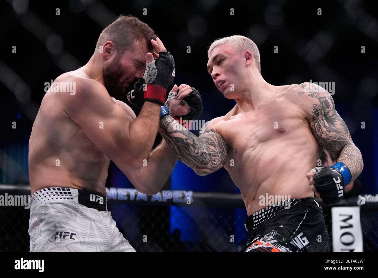 Navajo Stirling hits Ion Cutelaba during their light heavyweight bout ...