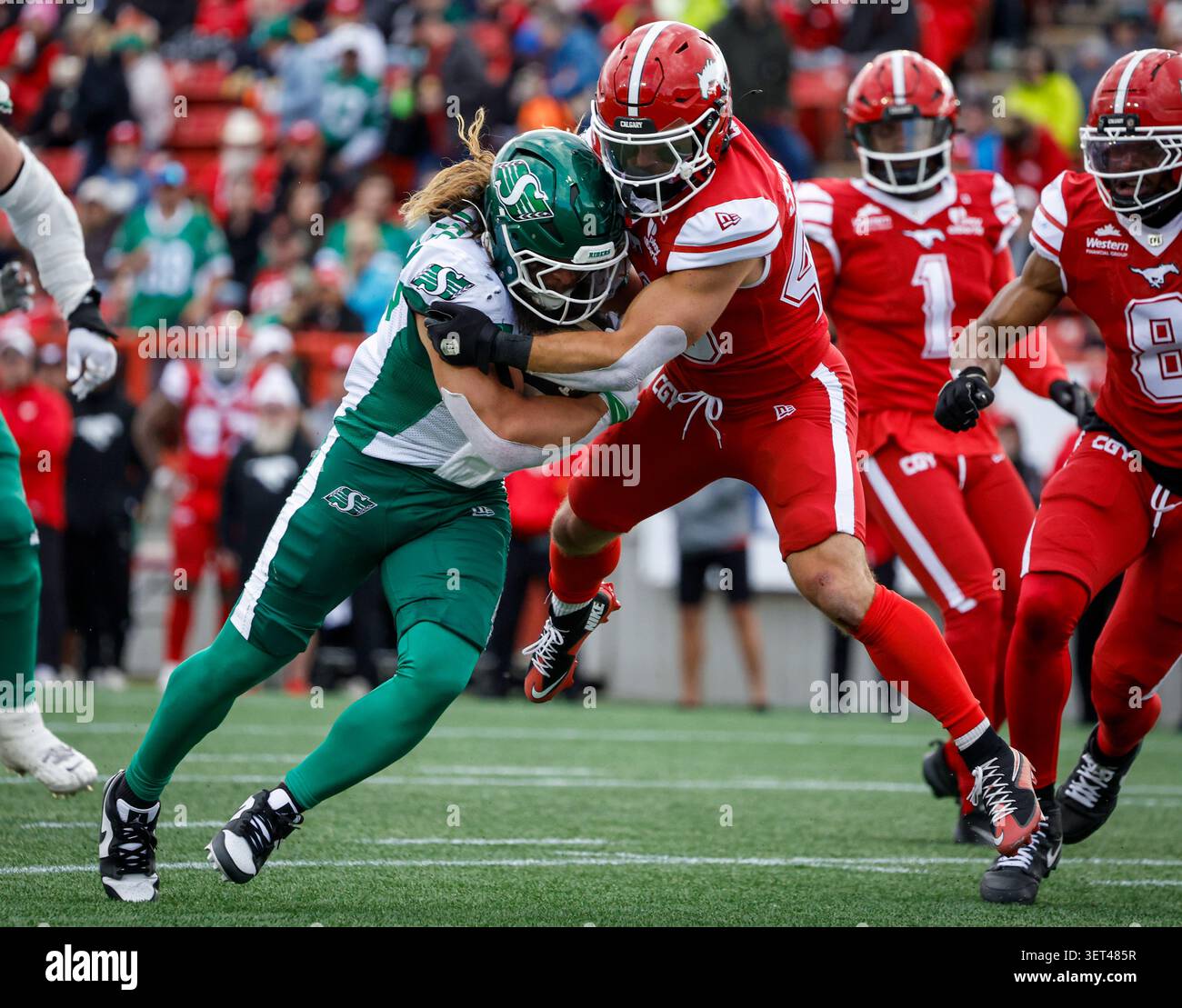 Saskatchewan Roughriders' Kian Schaffer-Baker, left, is grabbed by ...