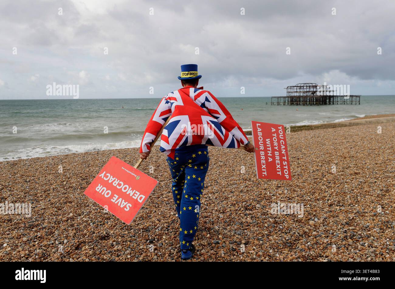 FILE- Anti Brexit campaigner Steve Bray walks on the beach to pose for ...