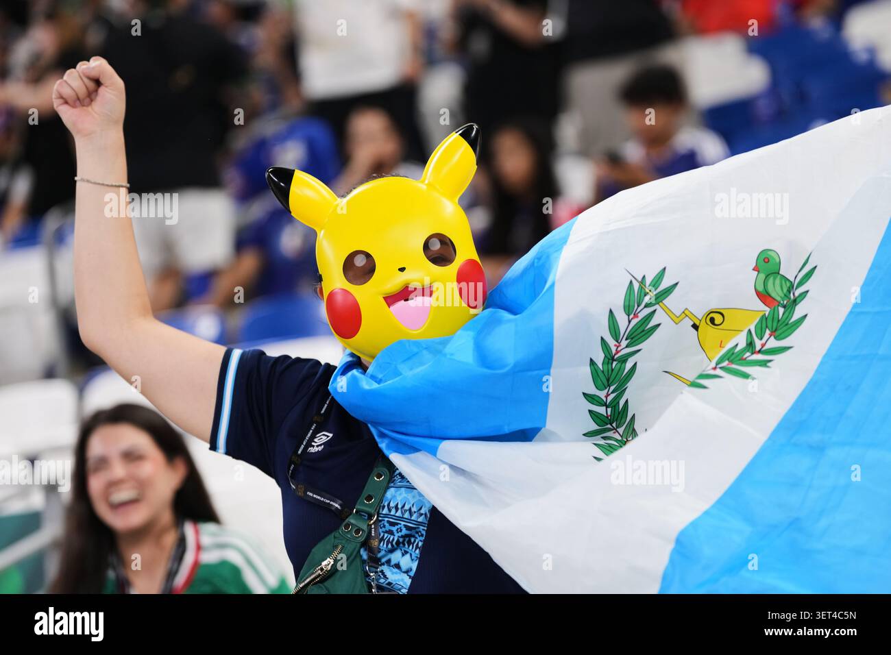 A fan wearing a mask of Pikachu character waits for the start of the ...