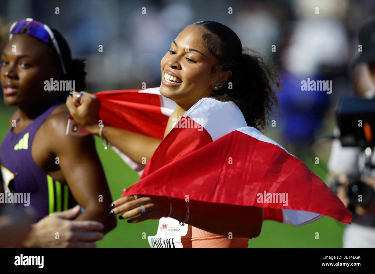 Tatiana Aholou, right, celebrates after winning the senior women's 100m ...