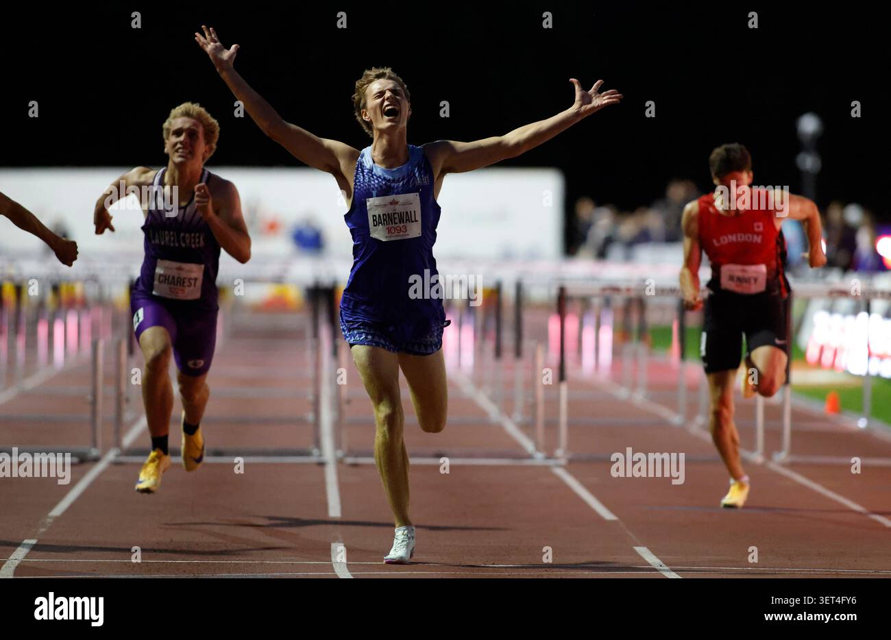 Kieran Barnewall, center, wins the under-20 men's 110m hurdles final ...