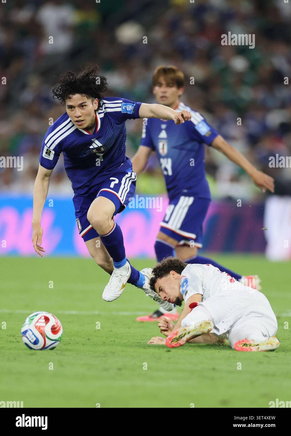 Japan's Ao Tanaka (7) chases the ball after colliding with Tunisia's ...