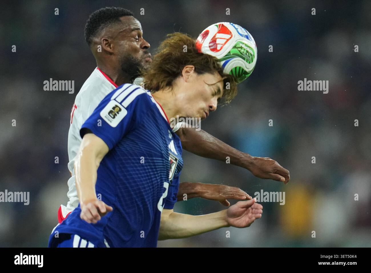 Japan's Ayumu Seko and Tunisia's Firas Chaouat go for a header during ...
