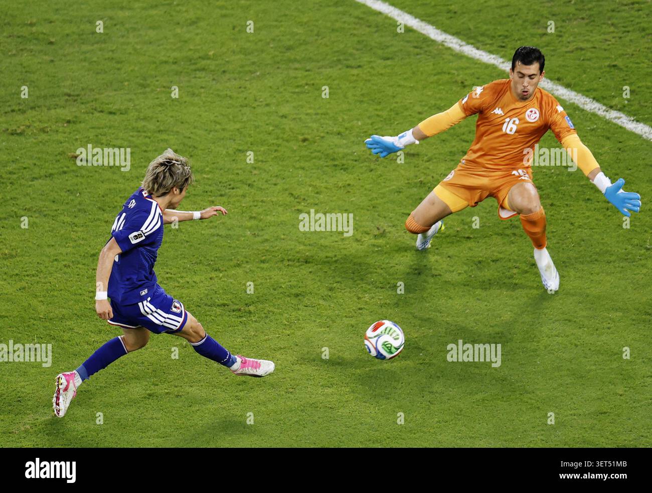 Japan's Junya Ito (L) scores the team's third goal in the second half ...
