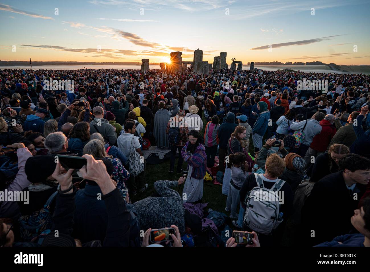 The sun rises through the stones as people gather at Stonehenge ...